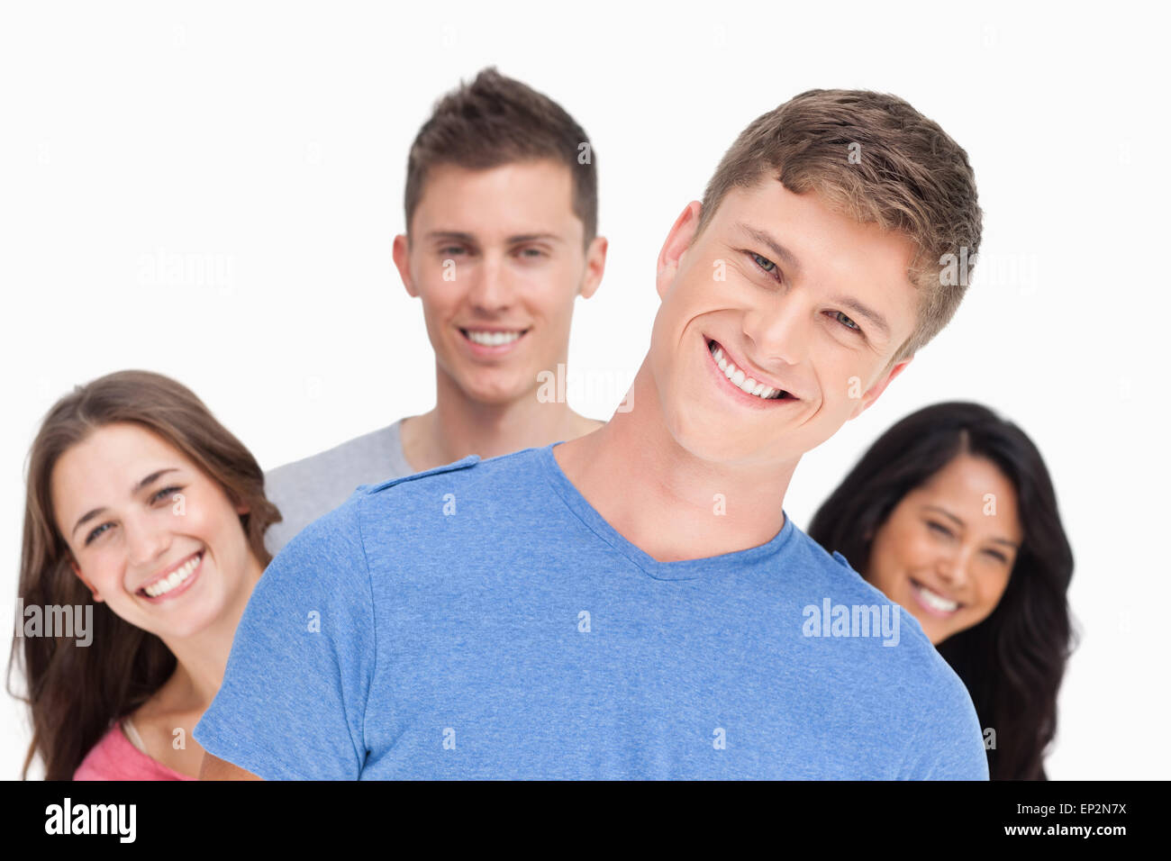 A man smiling with his head tilted and his friends behind him Stock ...