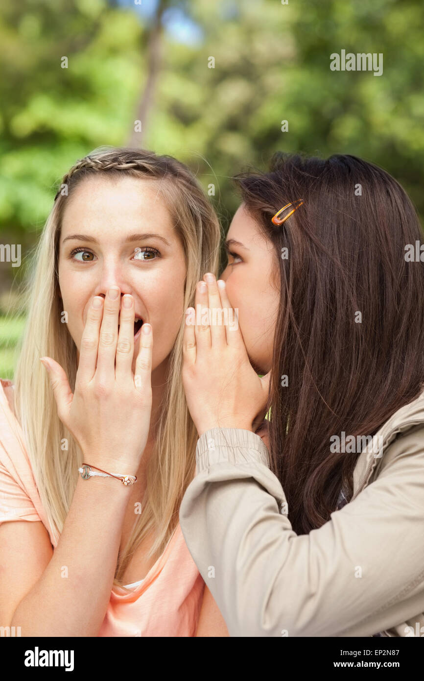 Close-up of female teenagers sharing a secret Stock Photo - Alamy