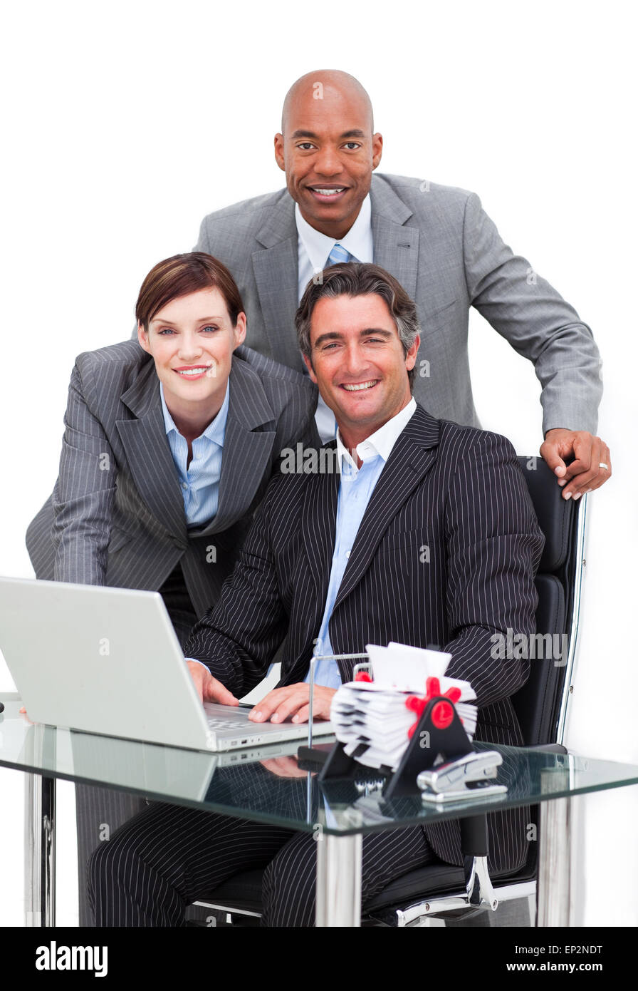 Self-assured business team working at a computer against a white ...