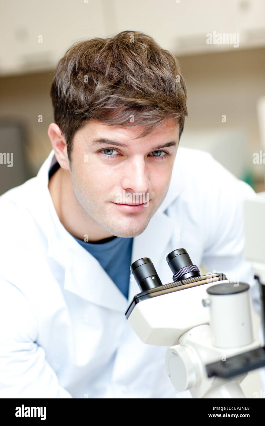 Handsome male scientist using a microscope Stock Photo - Alamy