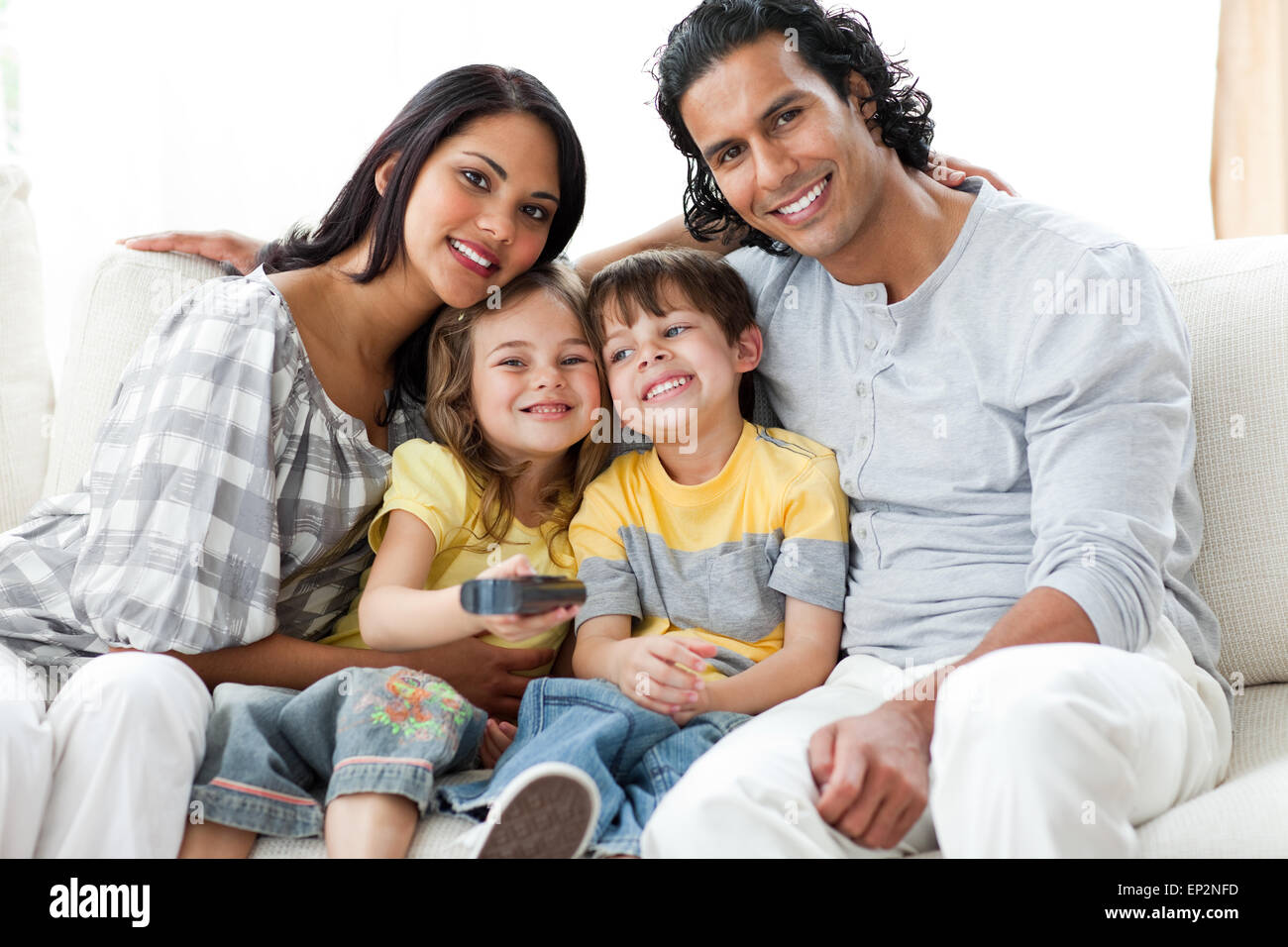 Cheerful family watching TV together Stock Photo - Alamy