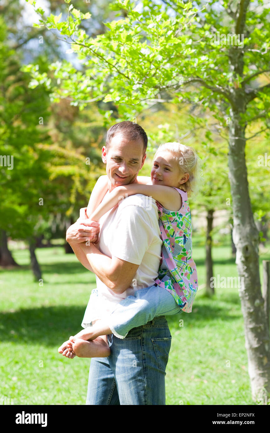 Lively father giving his daughter piggy-back ride Stock Photo - Alamy