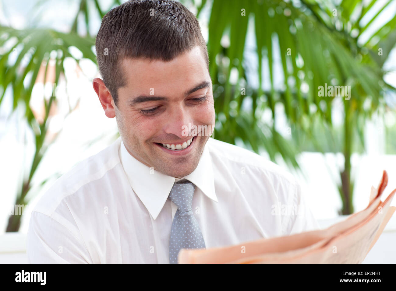 Businessman reading a newspaper in workplace Stock Photo - Alamy