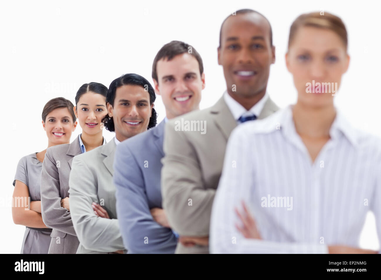 Close-up of happy workmates dressed in suits crossing their arms in a ...