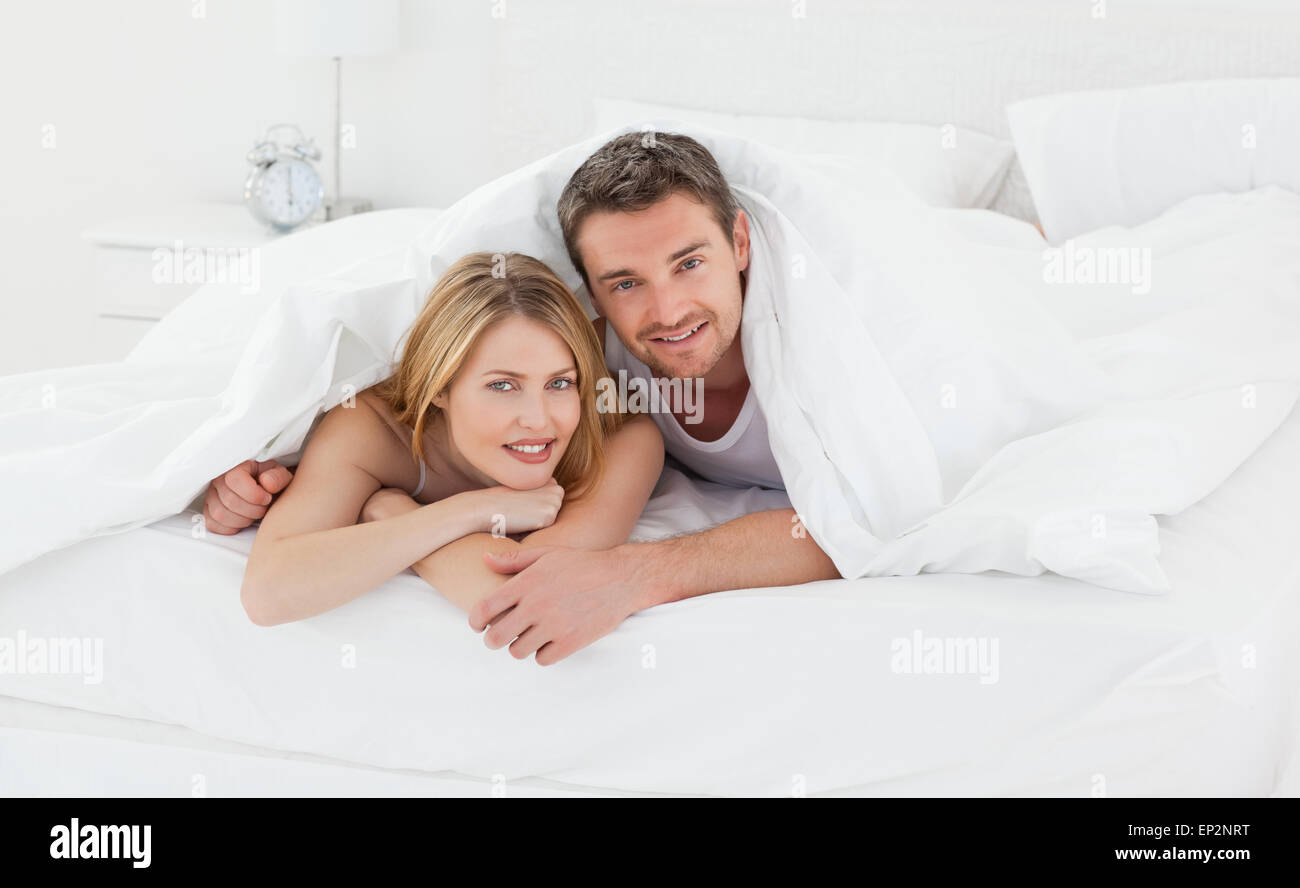 Lovely pair hugging in their bed Stock Photo - Alamy
