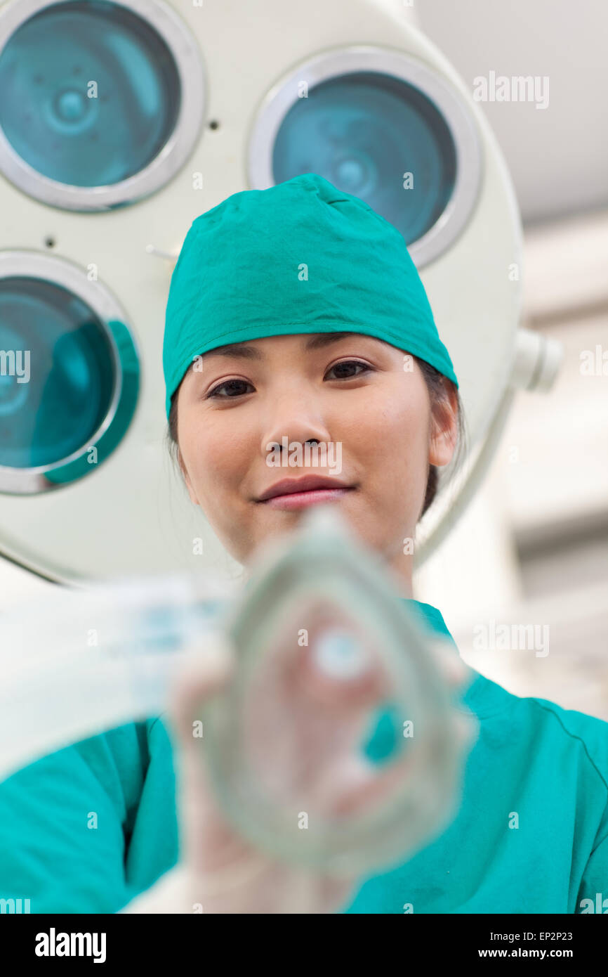 Young doctor applying oxygen mask to a patient Stock Photo - Alamy