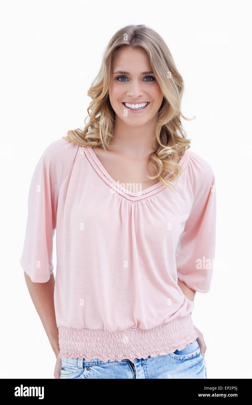 A smiling woman standing with her arms behind her back Stock Photo - Alamy