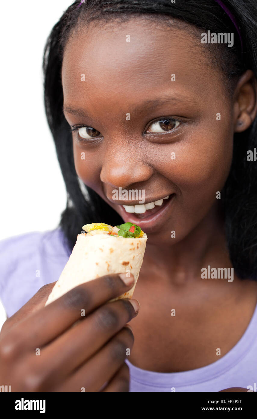 Smiling young woman eating a wrap Stock Photo - Alamy