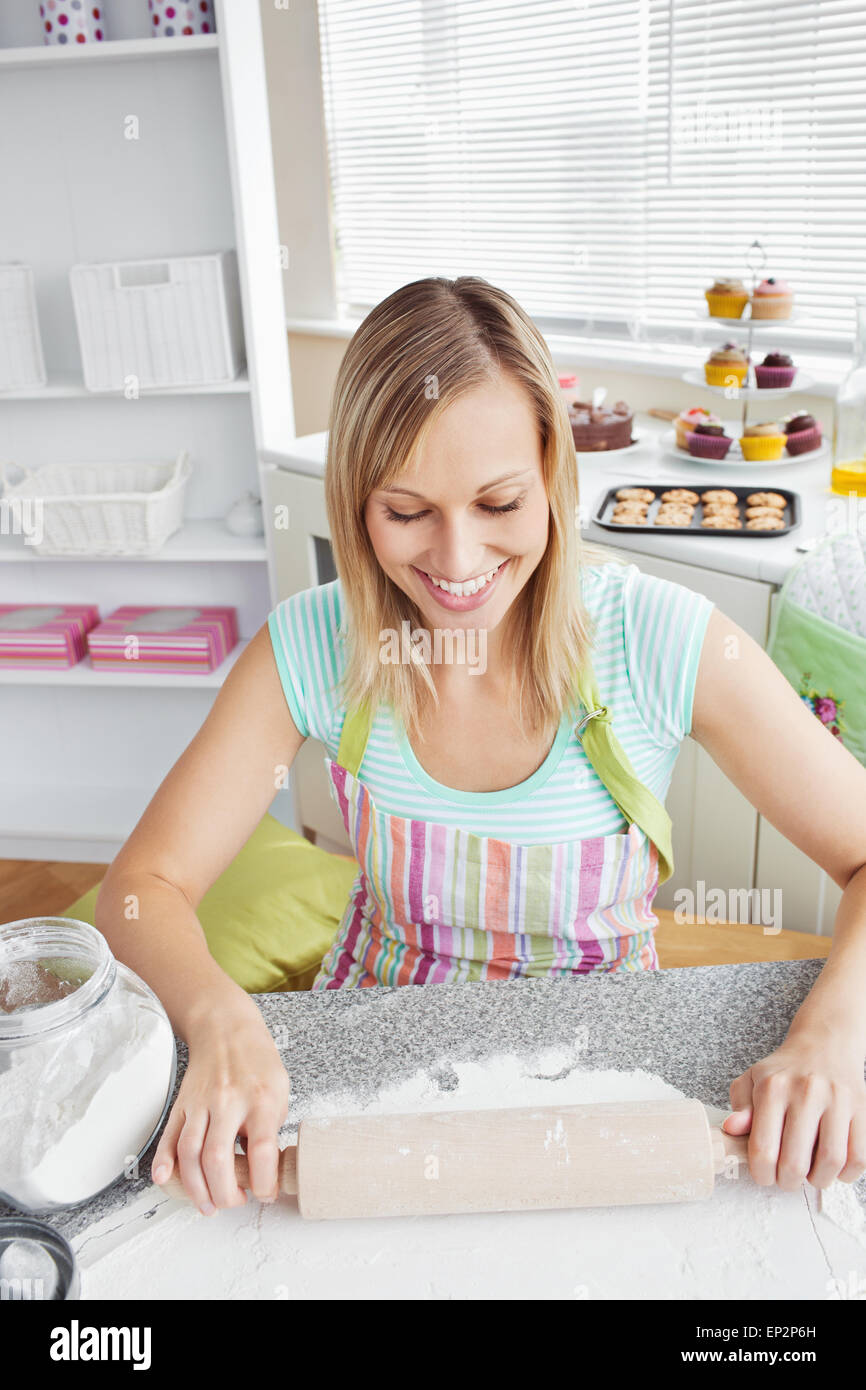 Smiling woman baking in the kitchen Stock Photo - Alamy