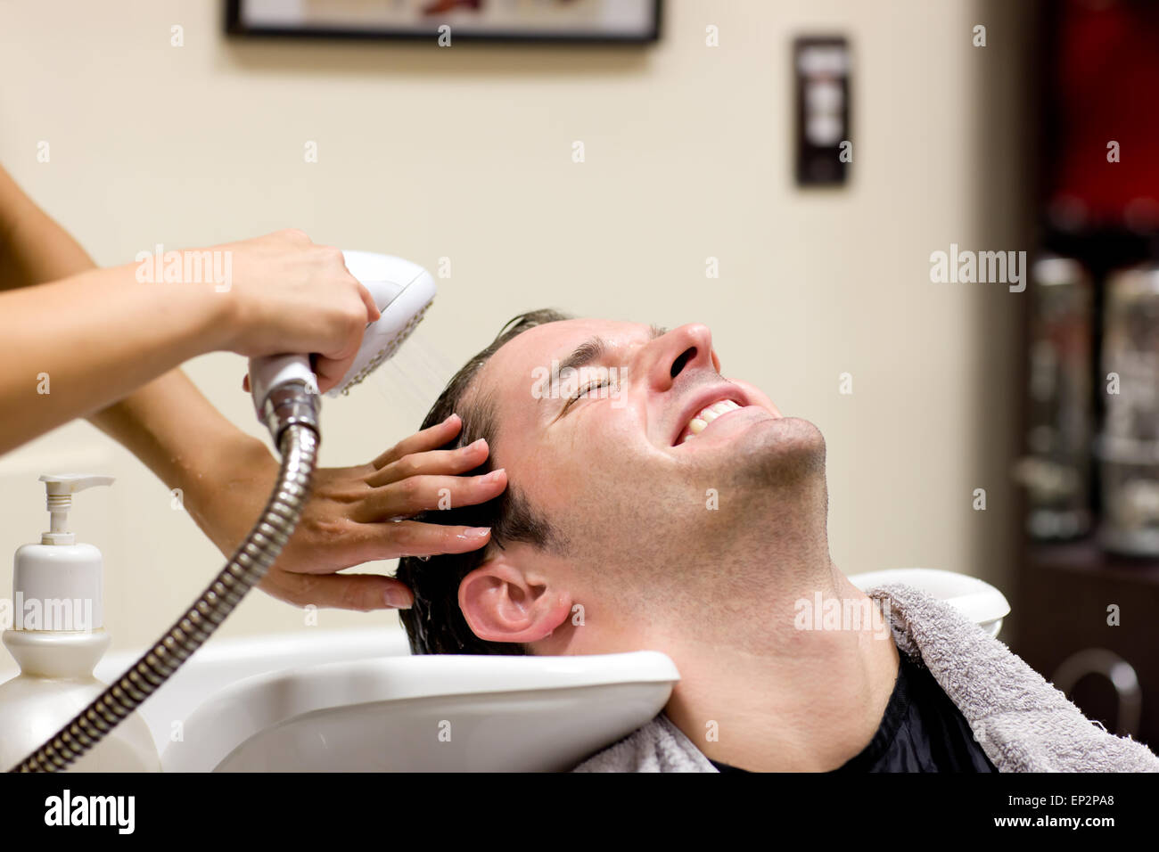 Handsome man having his hair washed Stock Photo - Alamy