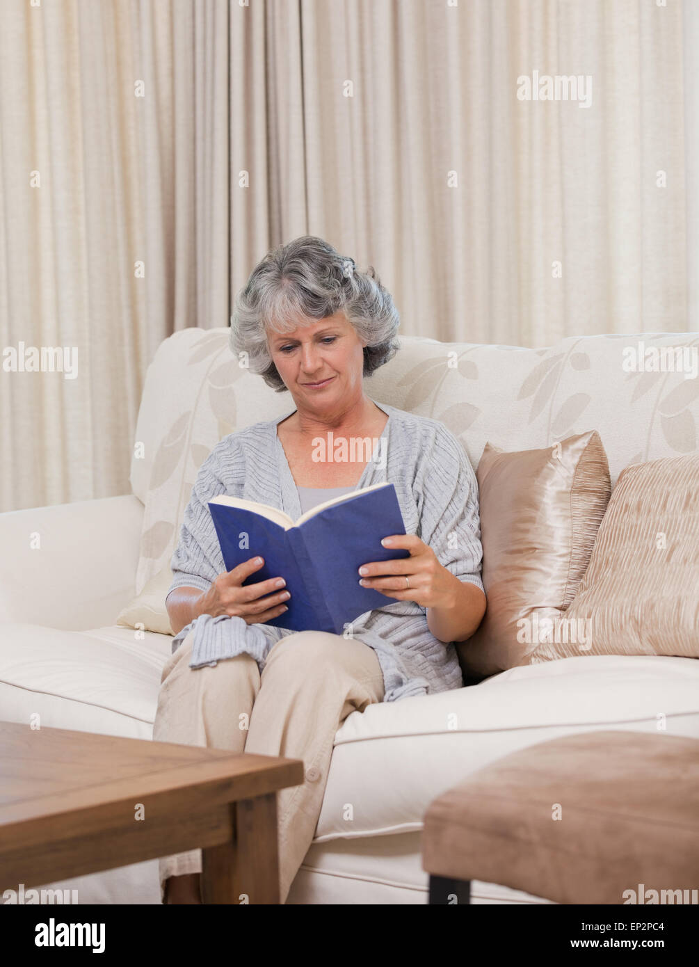 Senior woman reading her book Stock Photo - Alamy