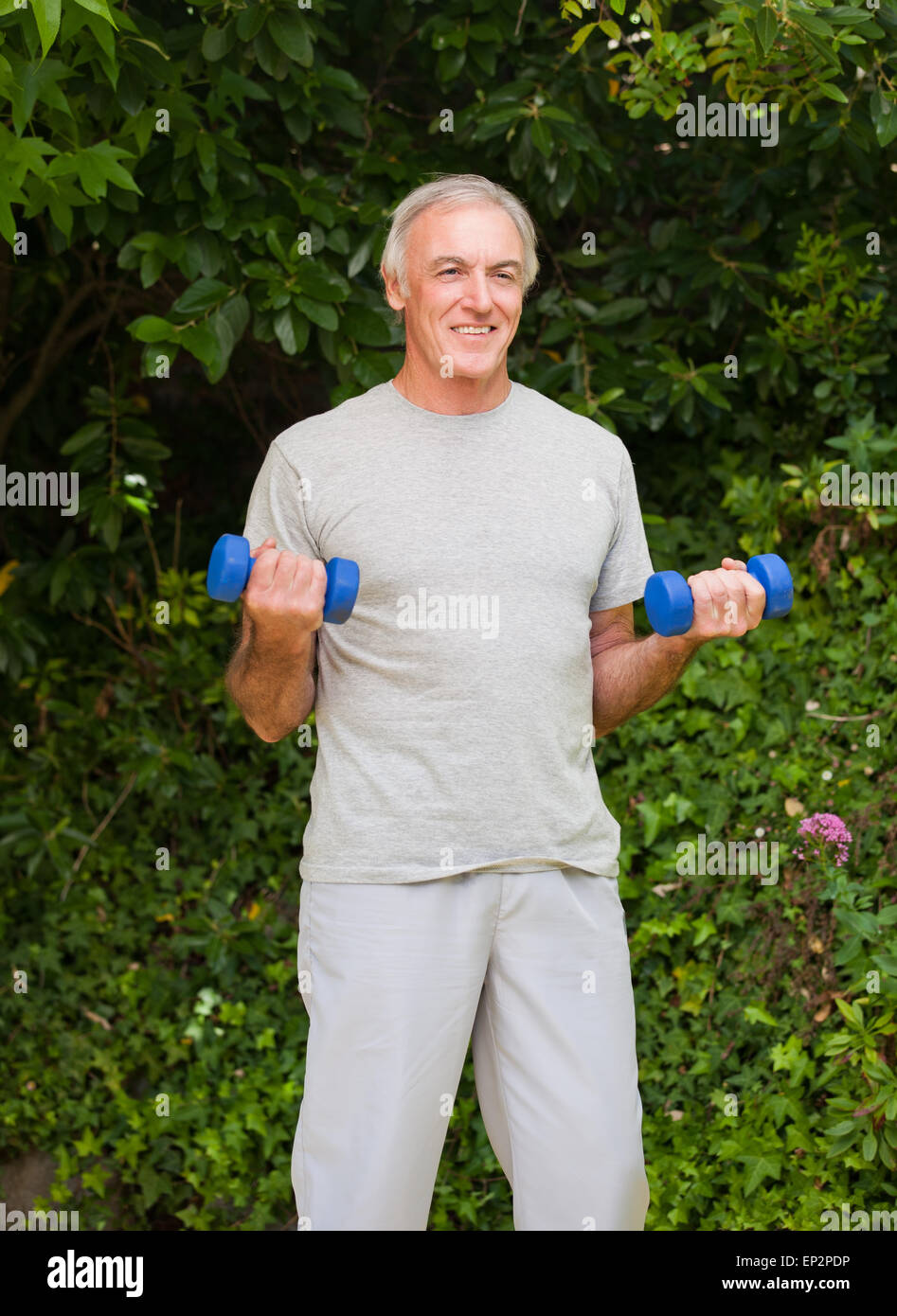 Senior man doing his exercises in the garden Stock Photo - Alamy