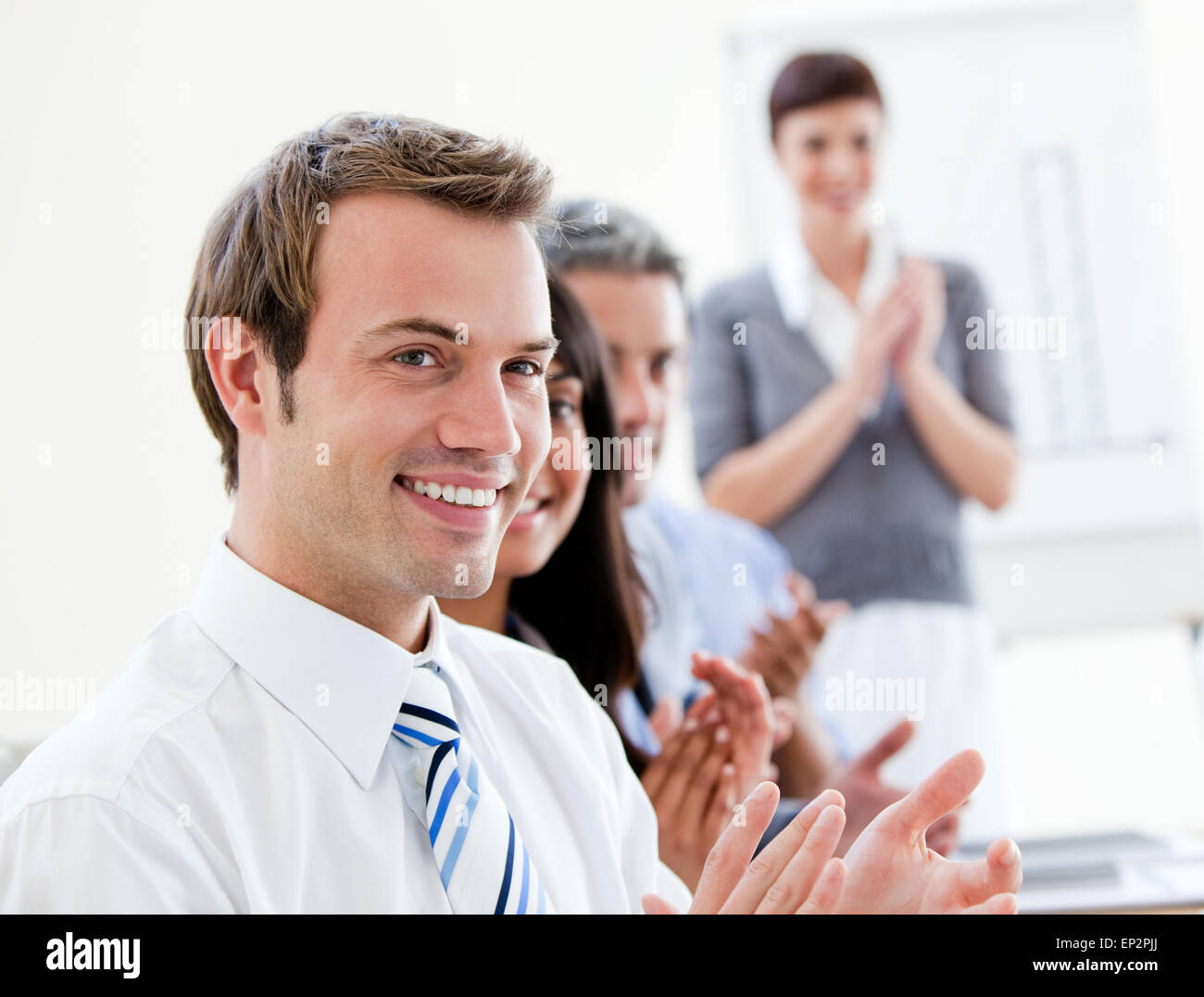 Smling business people applauding a good presentation Stock Photo - Alamy