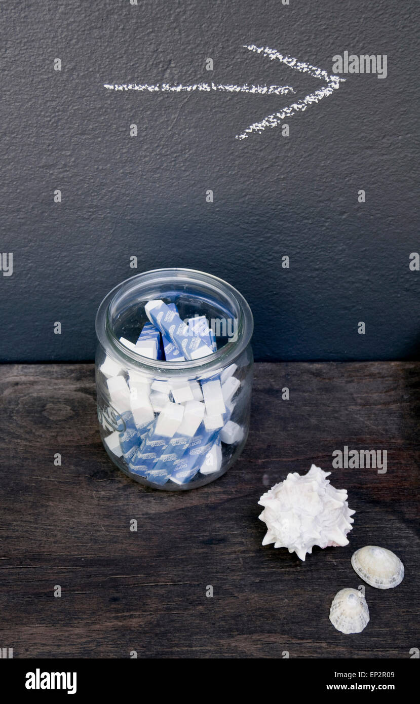 Jar with chalk, arrow sign, seashells and snailshell Stock Photo - Alamy