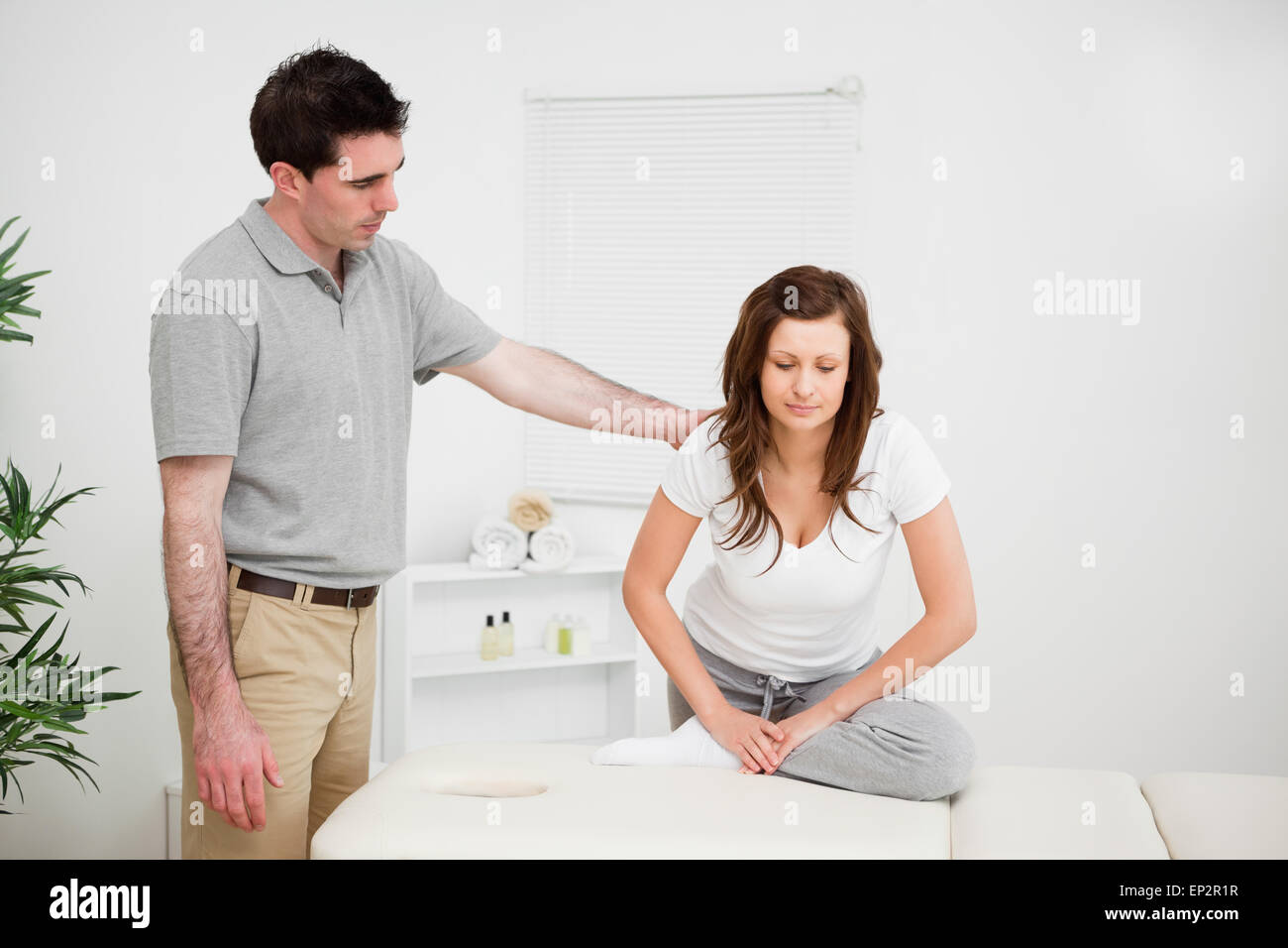 Peaceful woman doing stretching exercises with a doctor Stock Photo - Alamy