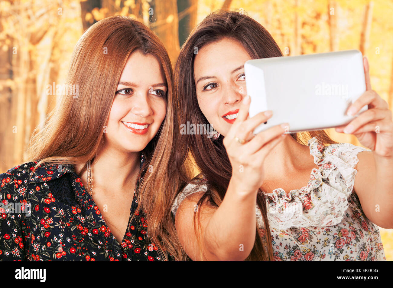Beautiful young trendy girls using tablet Stock Photo - Alamy