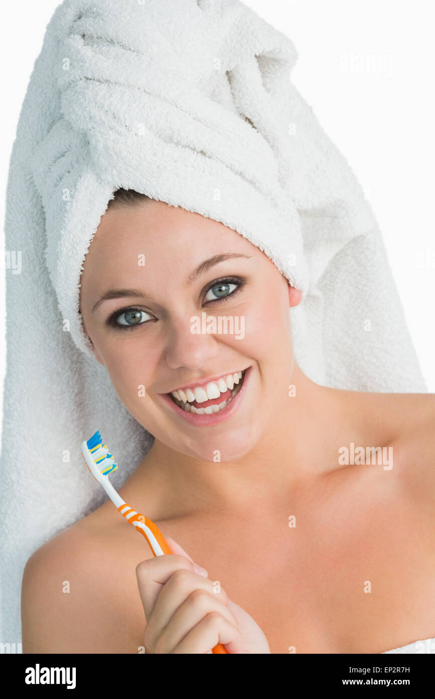 Happy woman with hair towel and her toothbrush Stock Photo - Alamy