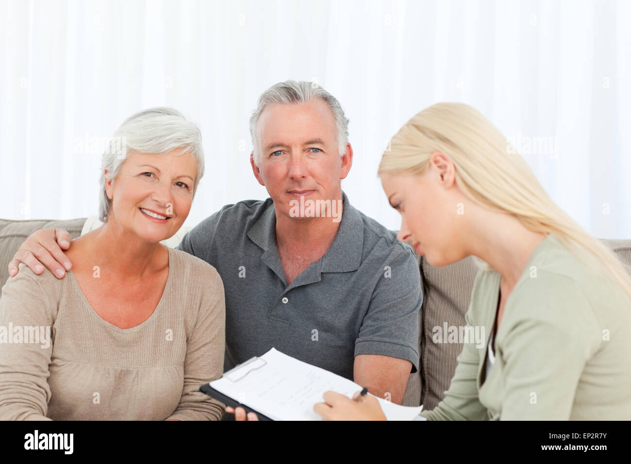 Seniors with doctor at home Stock Photo - Alamy