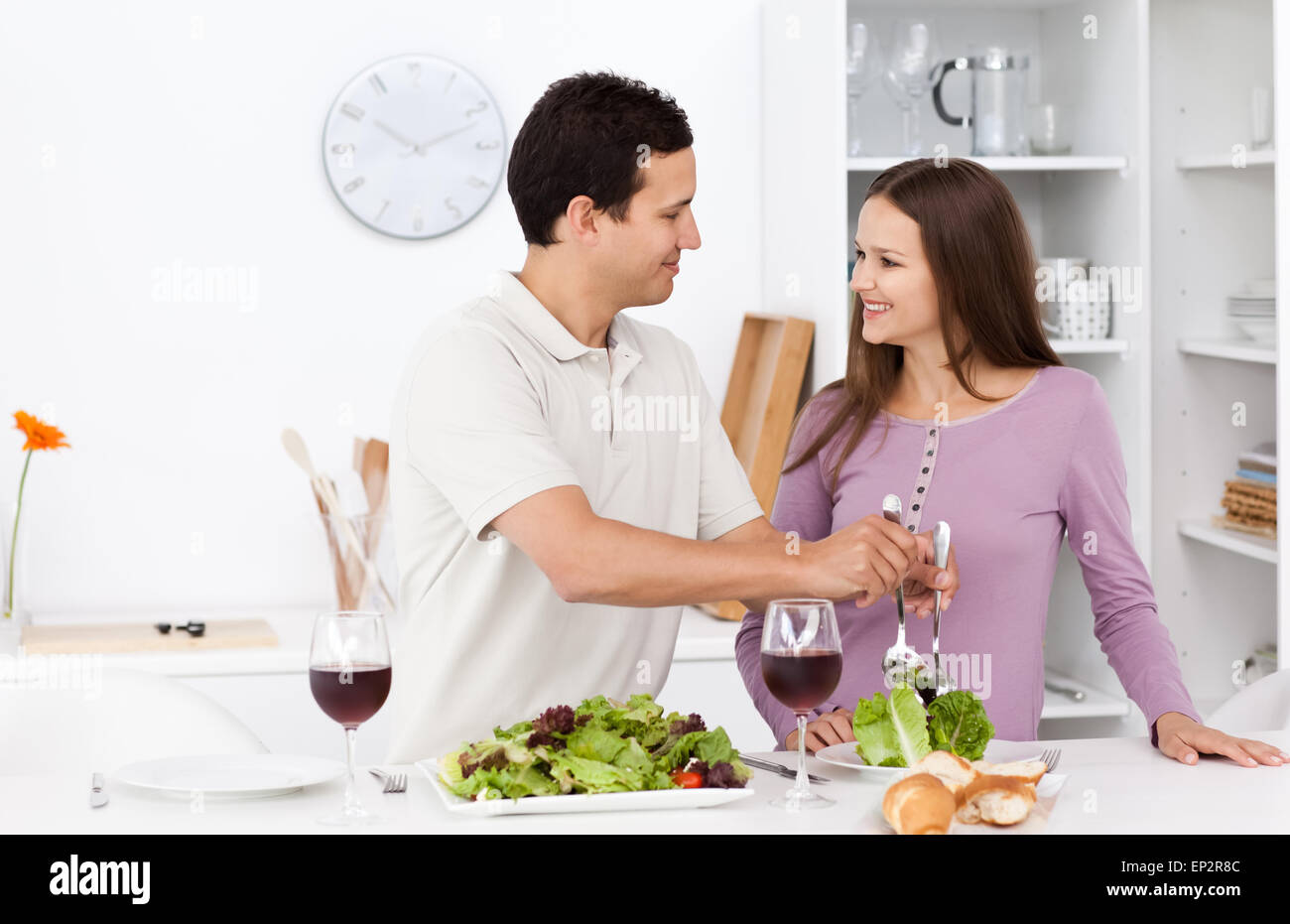 Attentive man serving salad to his girlfriend Stock Photo - Alamy