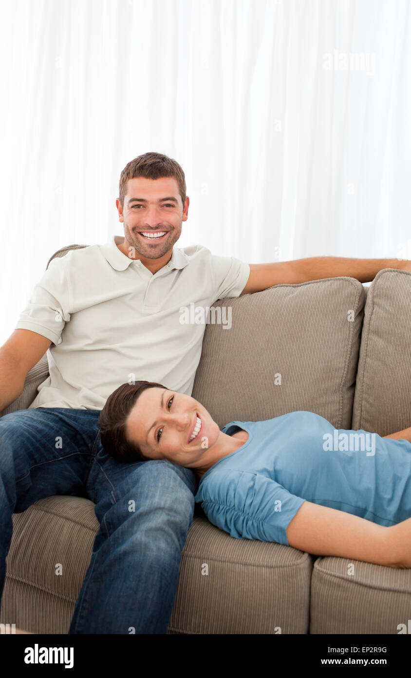Portrait of a cheerful couple resting together on the sofa Stock Photo ...