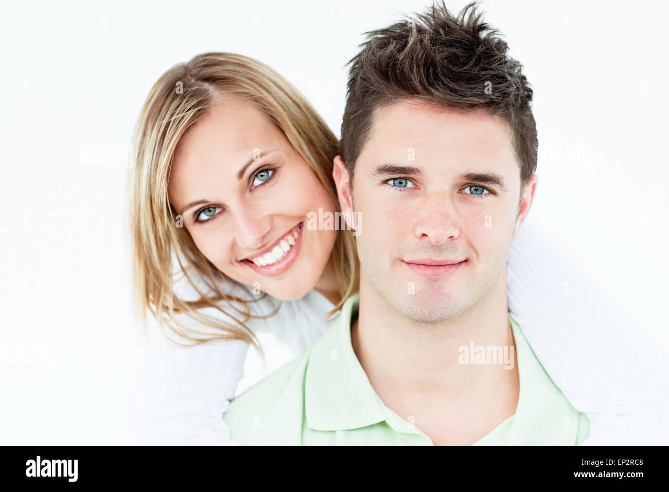 Portrait Of A Young Happy Couple Standing Against A White Background