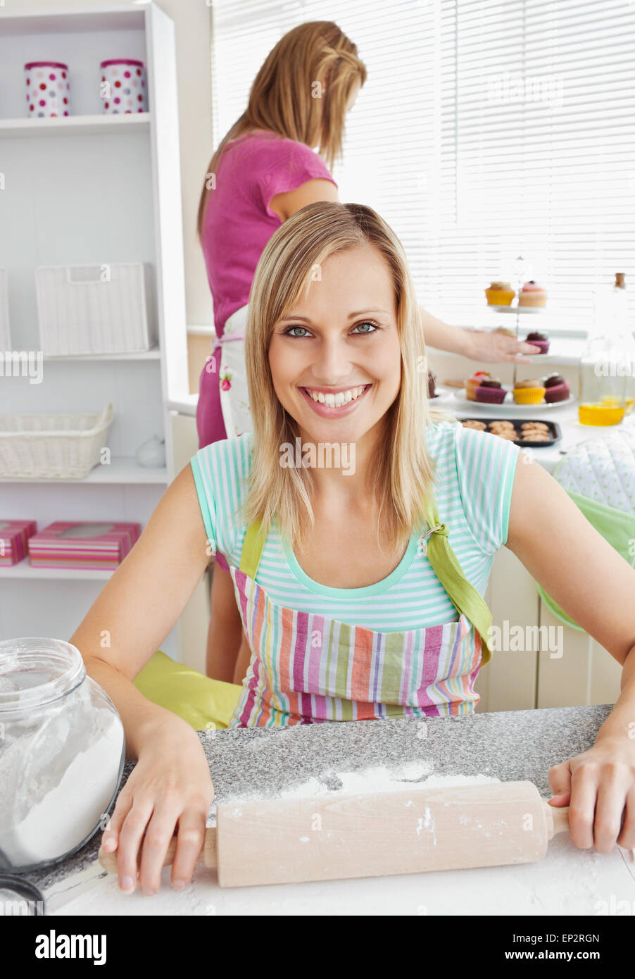 Beautiful caucasian woman baking together with her friend Stock Photo ...
