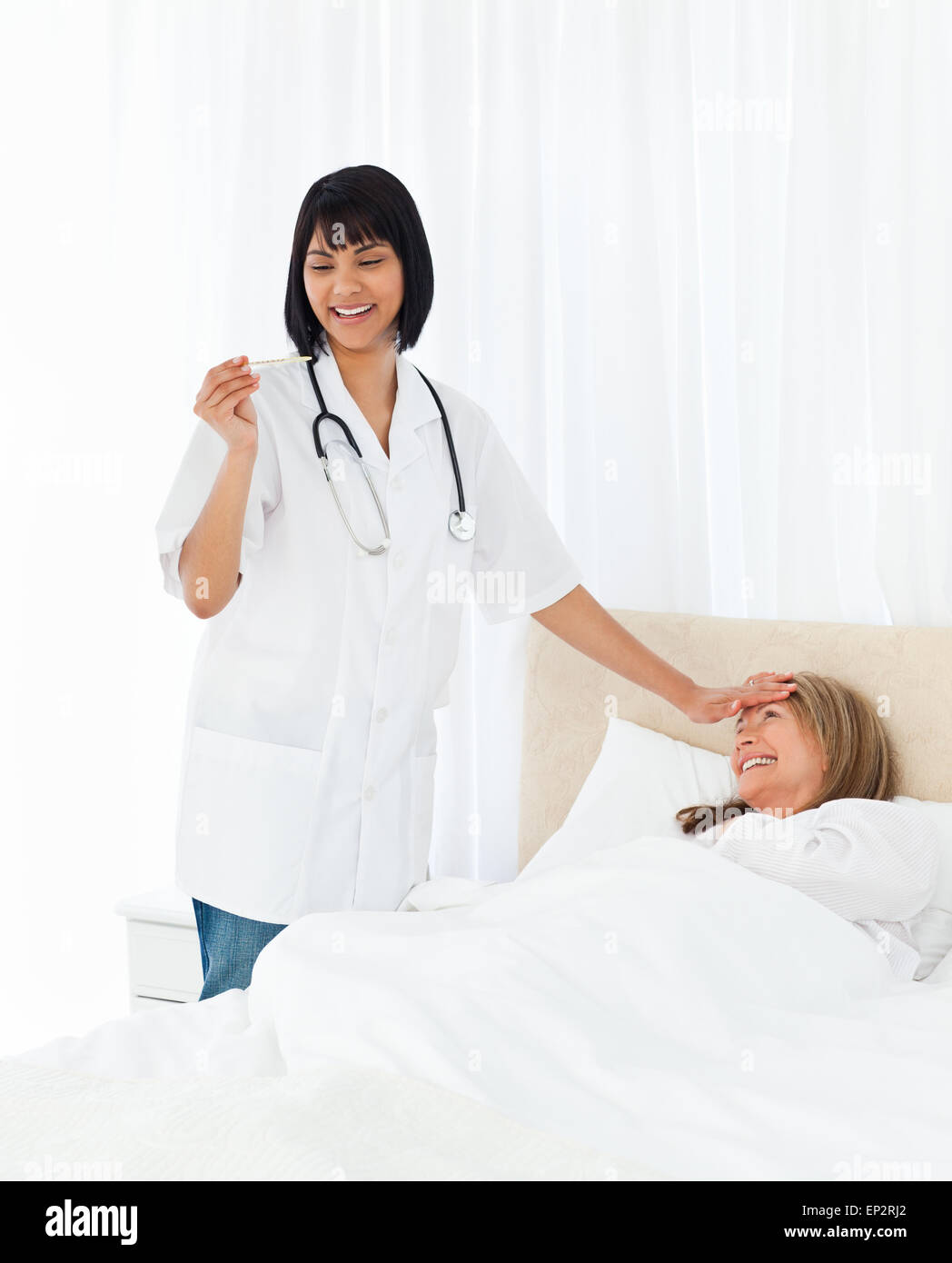 Nurse taking the temperature of her patient Stock Photo - Alamy