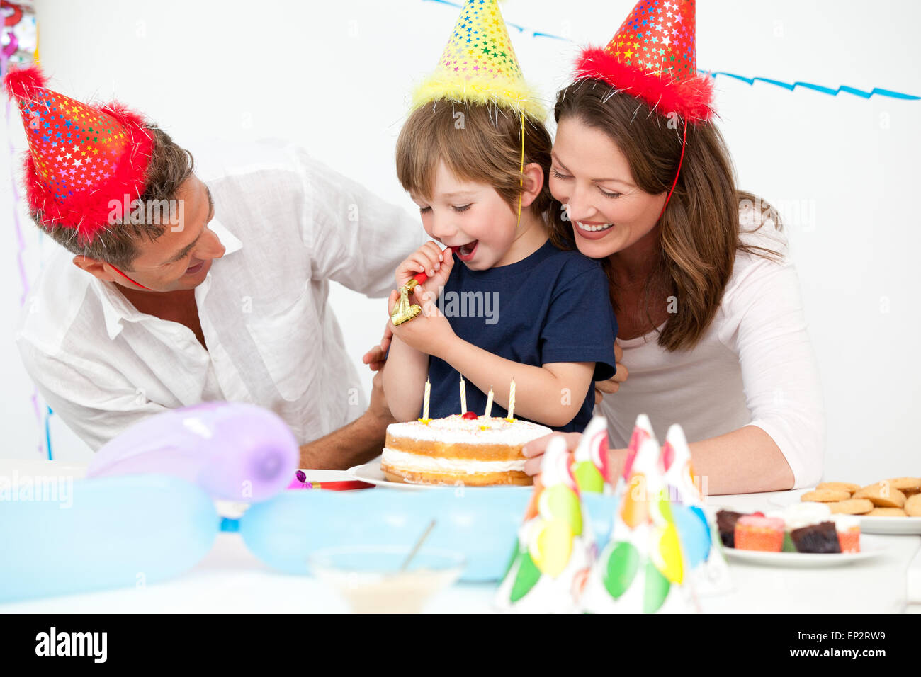 Happy parents celebrating their son's birthday Stock Photo - Alamy