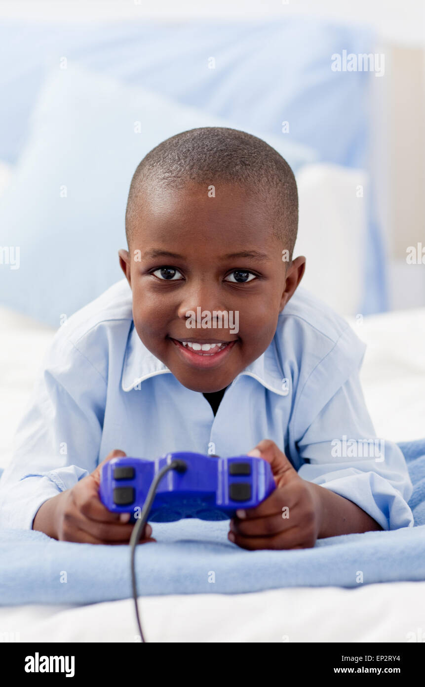 Cute little boy playing video game Stock Photo - Alamy