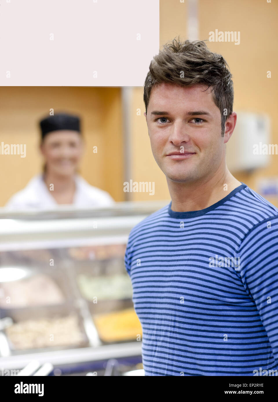 Portrait of a cheerful man choosing his lunch in the cafeteria Stock ...
