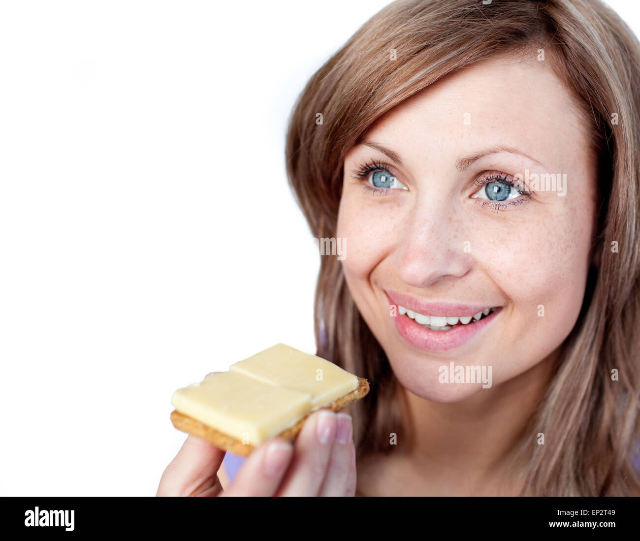 Cheerful woman eating a cracker with cheese isolated on a white ...
