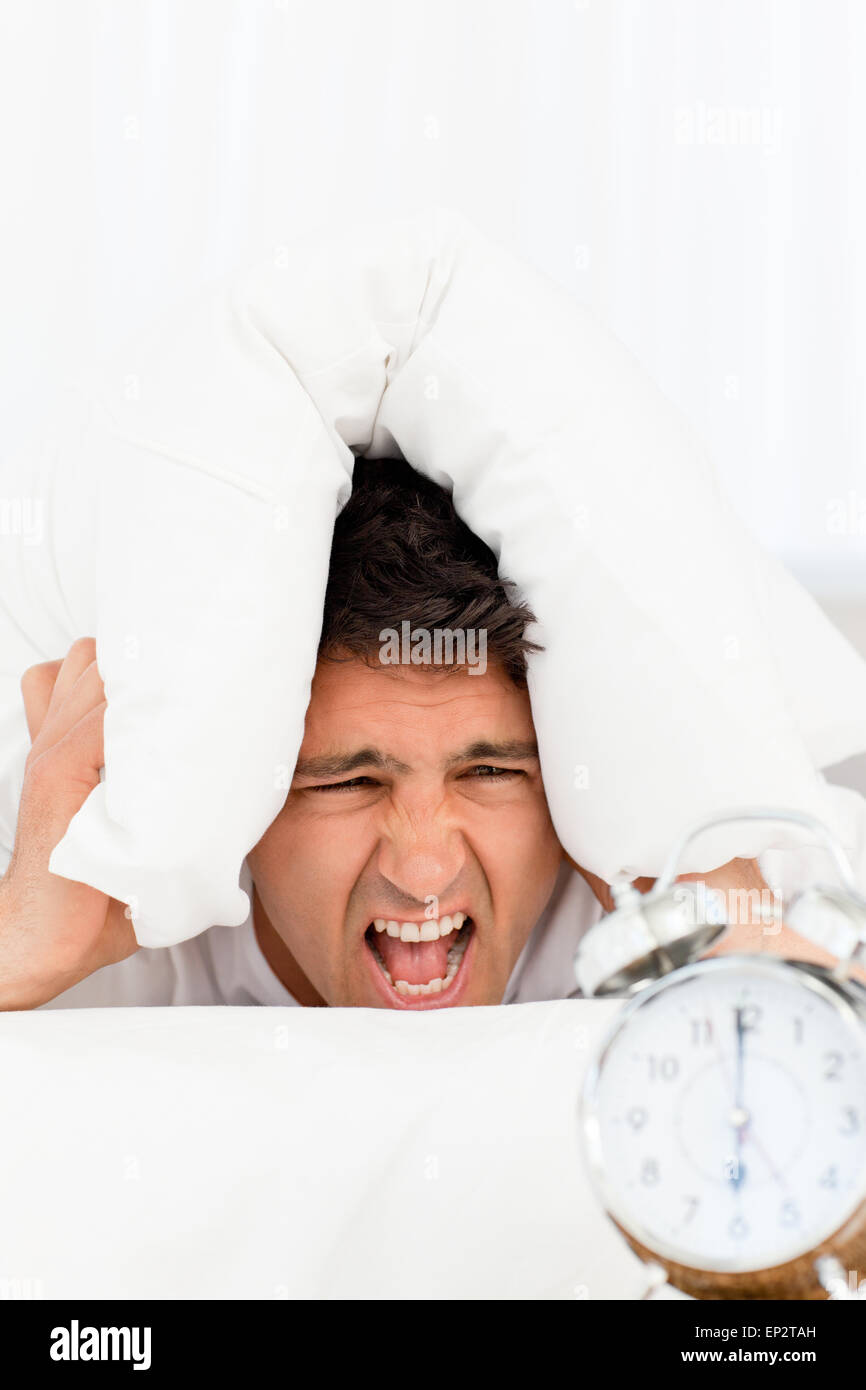 Unhappy man screaming while his alarm clock ringing Stock Photo - Alamy