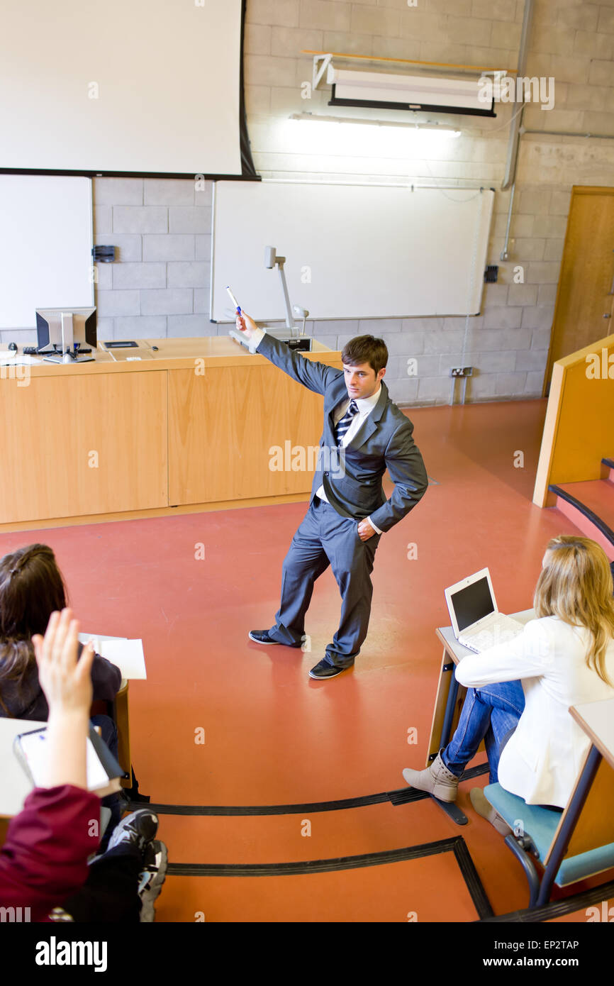 Confident teacher giving a lesson to university students Stock Photo ...