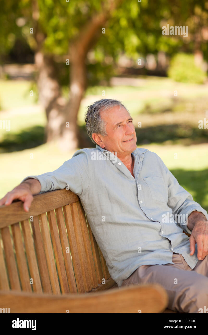 Senior man sitting on a bench Stock Photo - Alamy