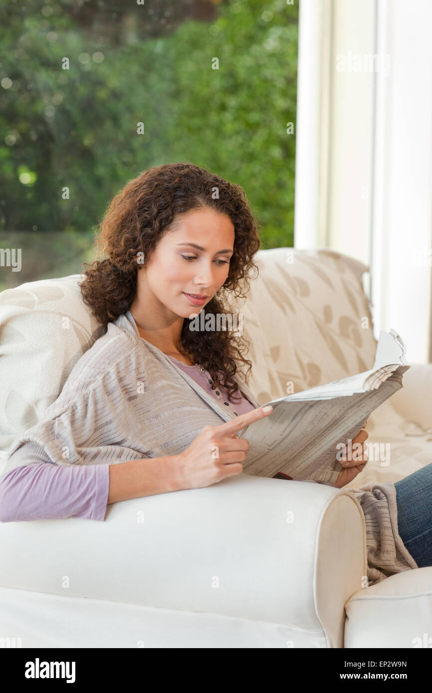 Woman reading the newspaper Stock Photo - Alamy