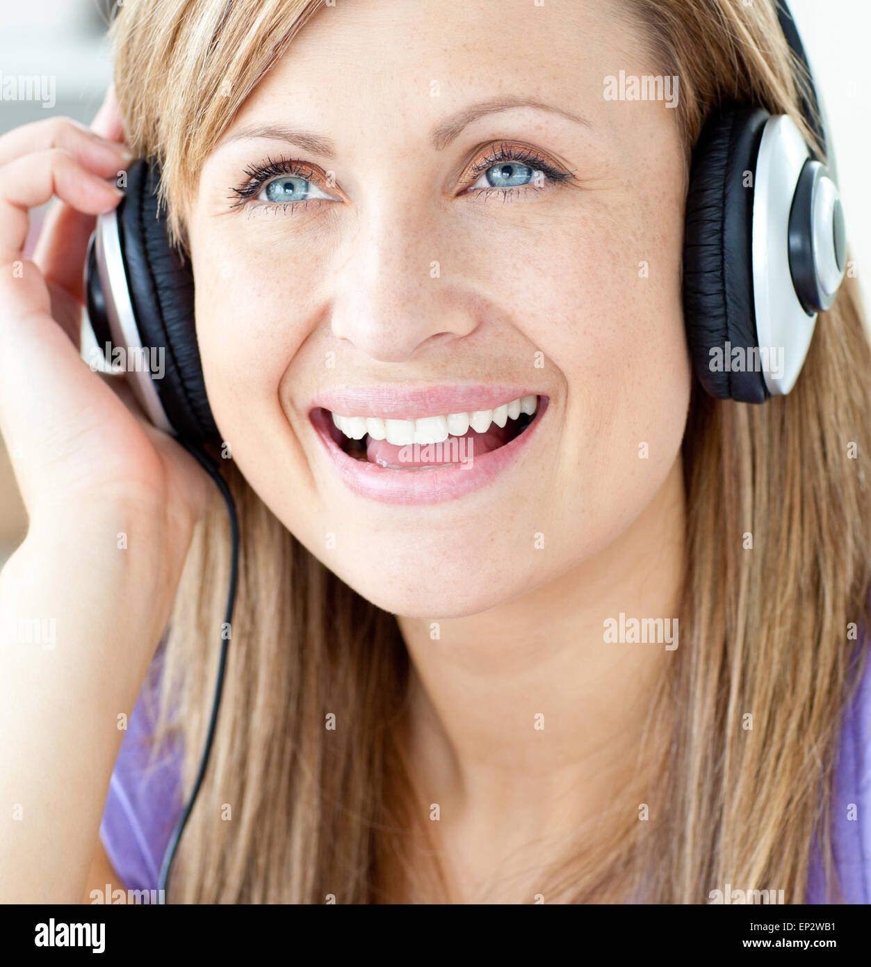 Laughing woman listening to music Stock Photo - Alamy