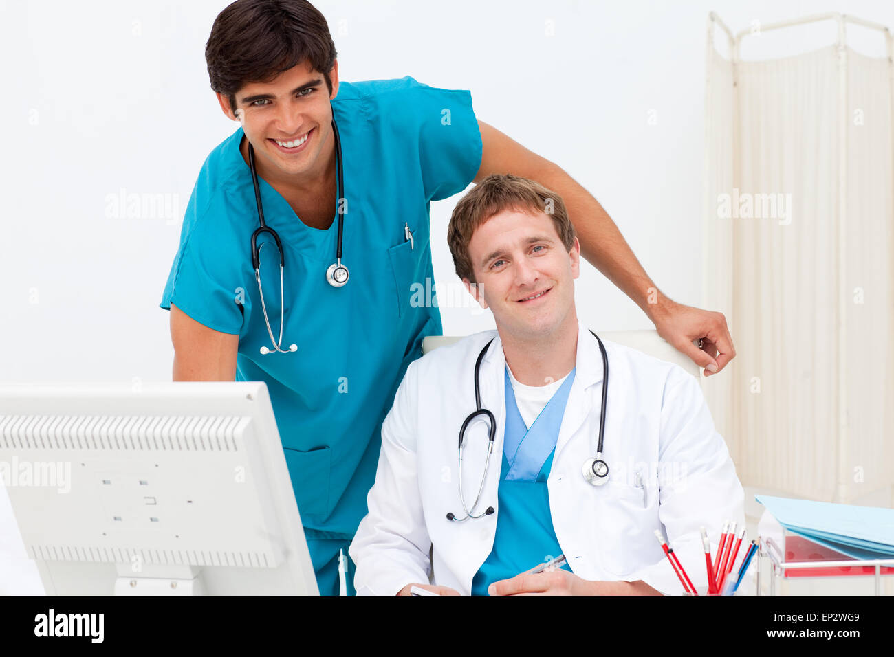 Portrait of a doctor and a medical intern working together Stock Photo ...
