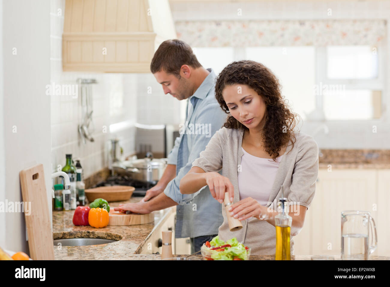 Handsome man cooking with his girlfriend Stock Photo - Alamy