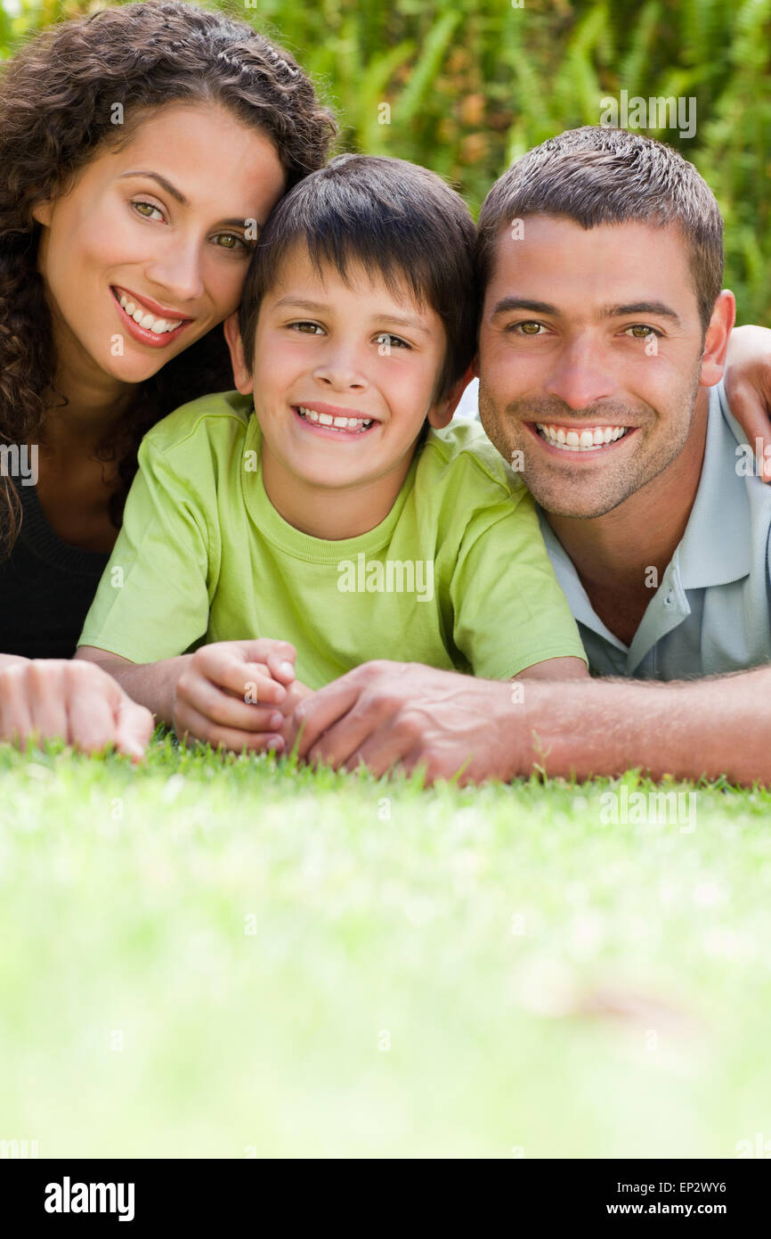 Little boy with his parents lying down in the garden Stock Photo - Alamy