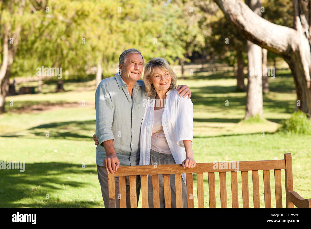Portrait of a lovely couple behind the bench Stock Photo - Alamy