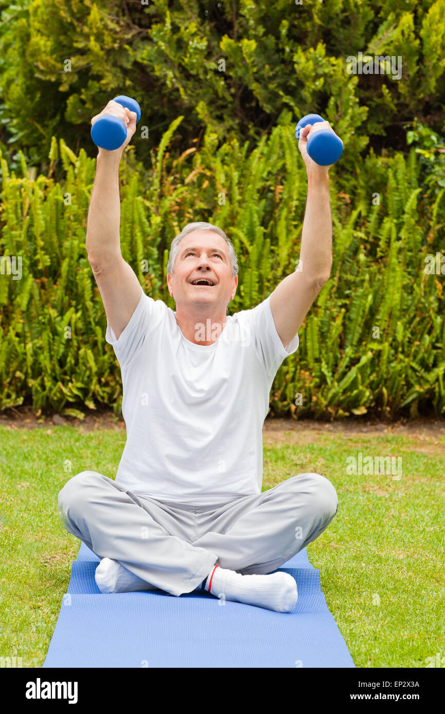 Retired man doing his exercises in the garden Stock Photo - Alamy