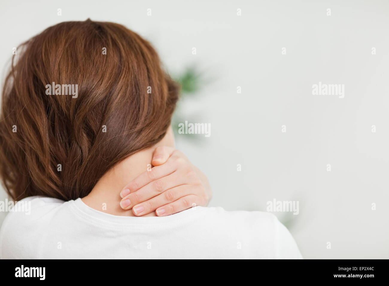 Close up of a brunette woman massing her neck Stock Photo - Alamy