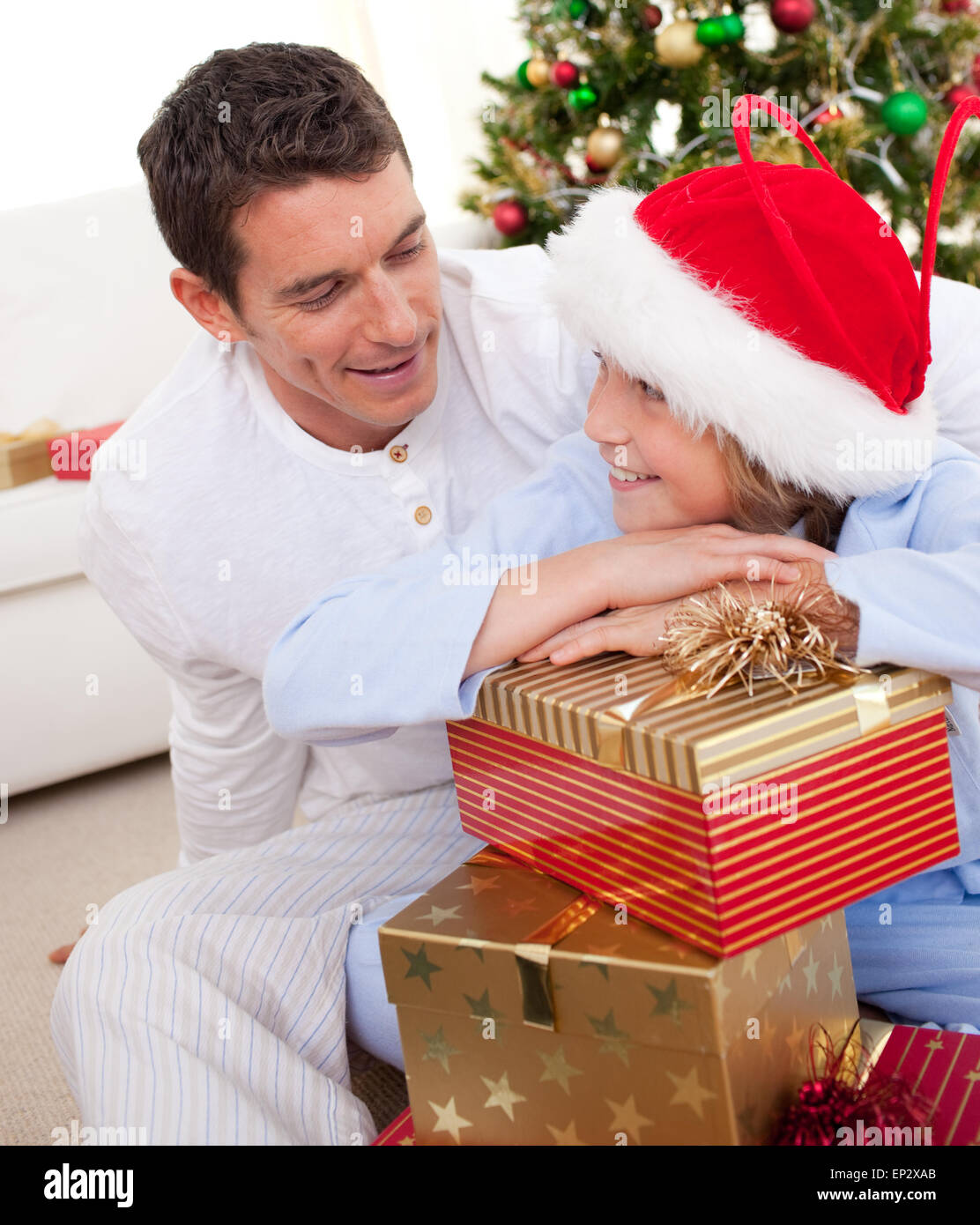 Smiling father and his son unpacking Christmas gifts Stock Photo - Alamy