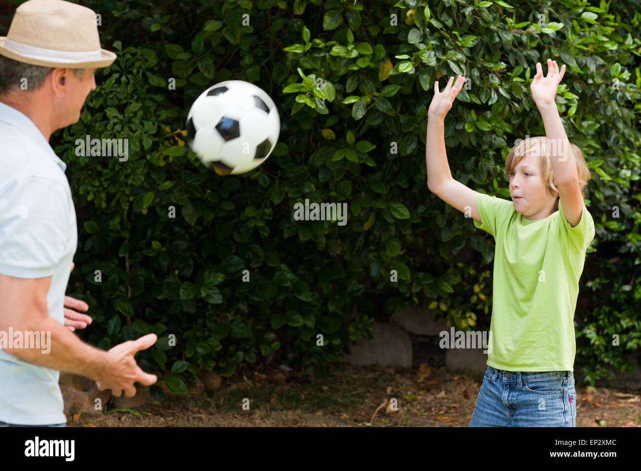 Grandfather and his grandson playing football Stock Photo - Alamy