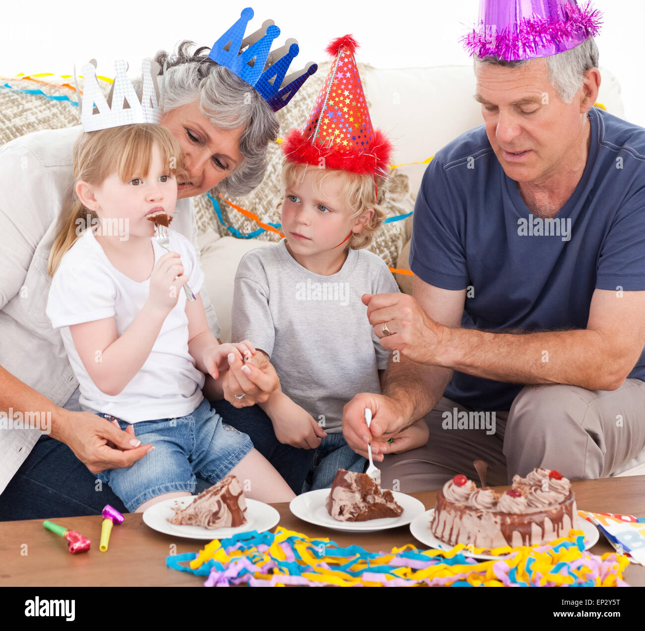 Family eating the birthday cake together Stock Photo - Alamy