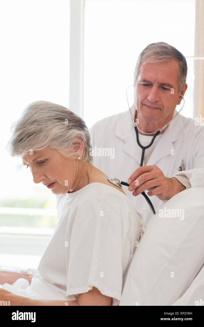 Senior doctor taking the heartbeat of his patient Stock Photo - Alamy