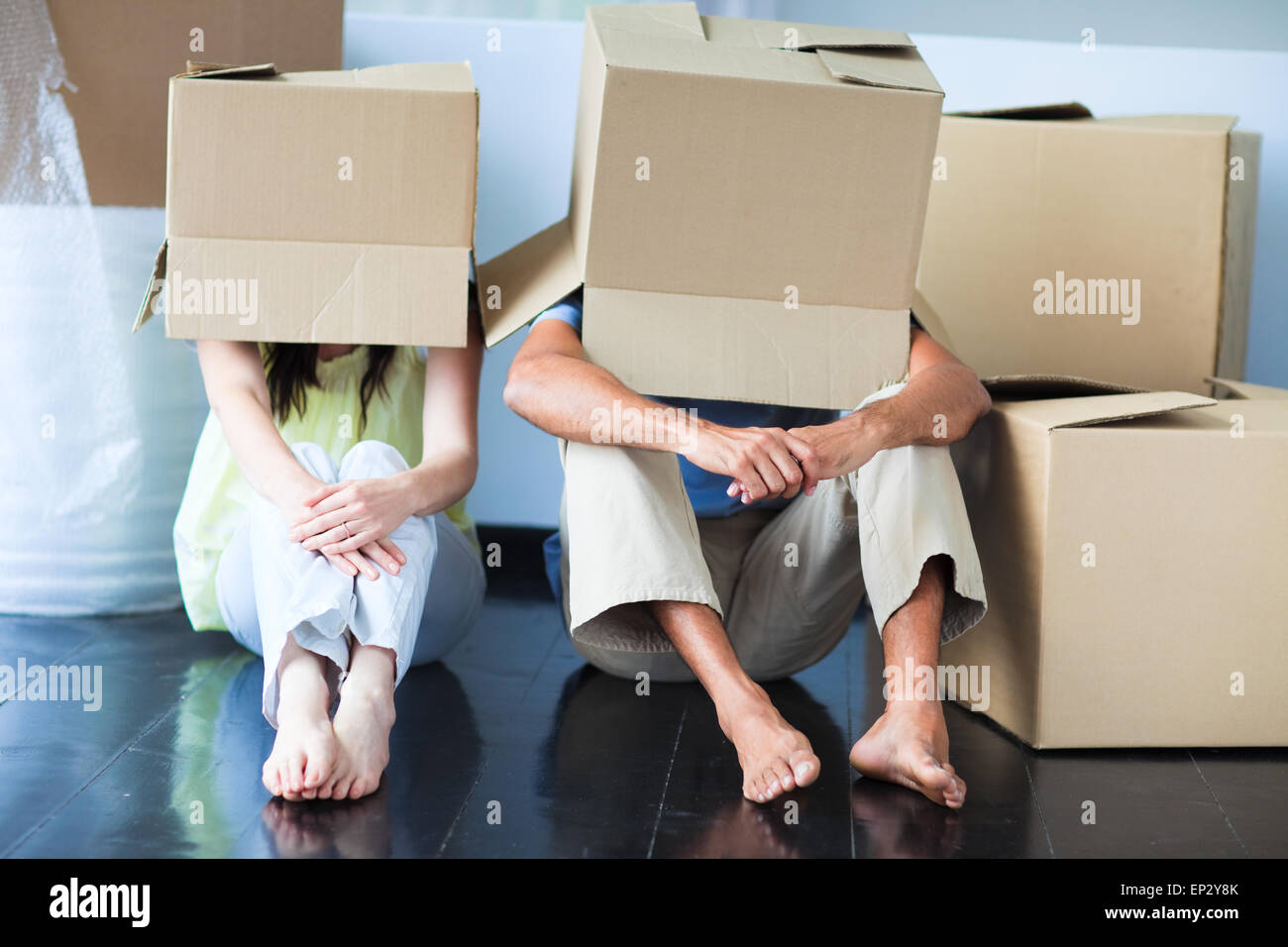 People under cartons Stock Photo - Alamy