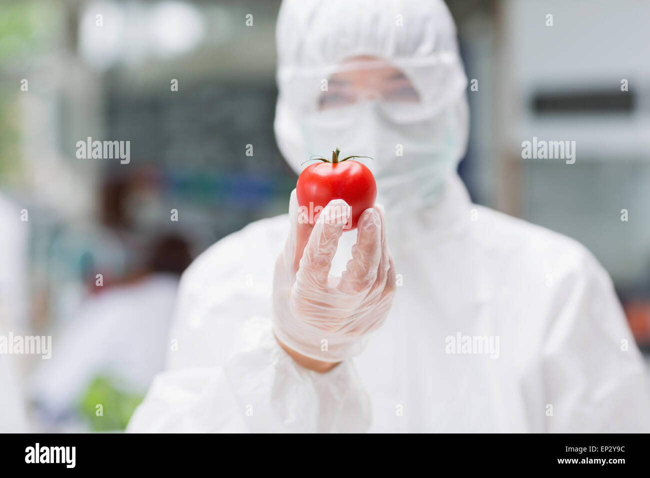 Woman standing at the laboratory wearing protection suit Stock Photo ...