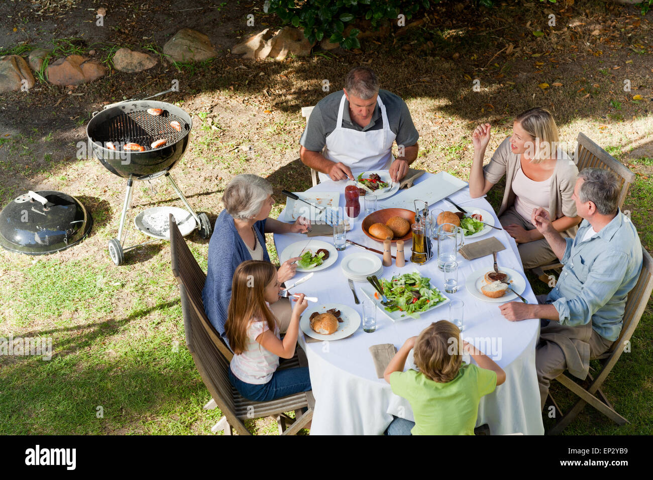Adorable family eating in the garden Stock Photo - Alamy