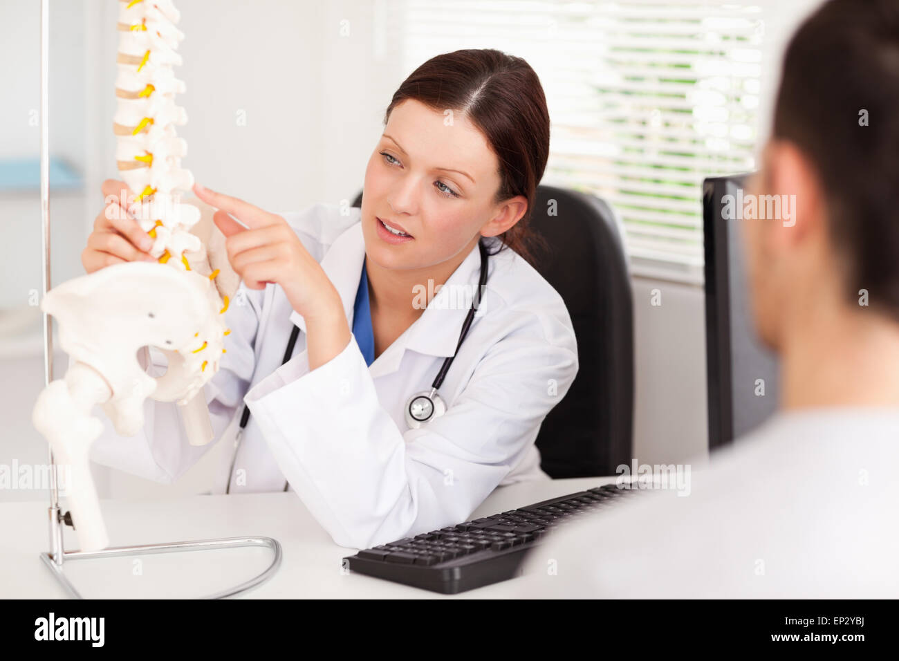 Female doctor pointing on a bone Stock Photo - Alamy